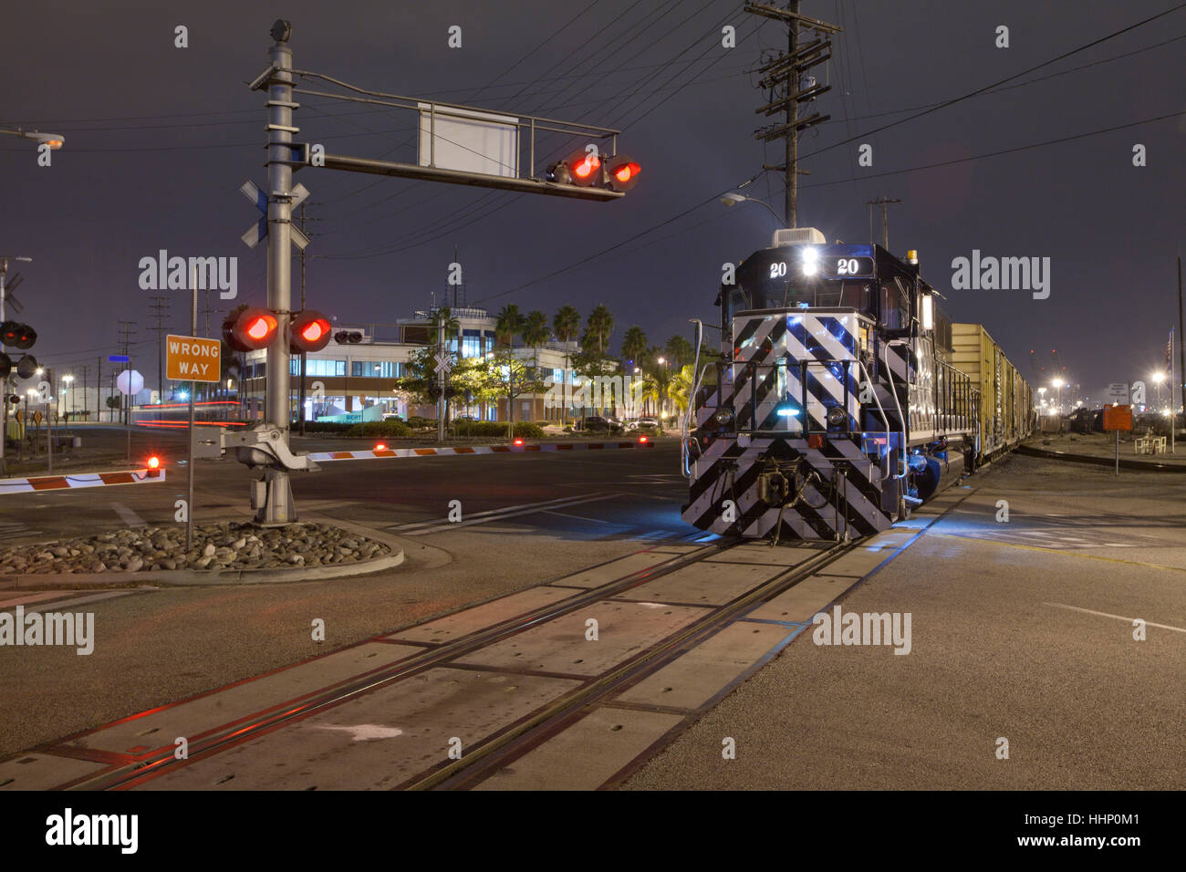 Train at railroad crossing at night Stock Photo - Alamy