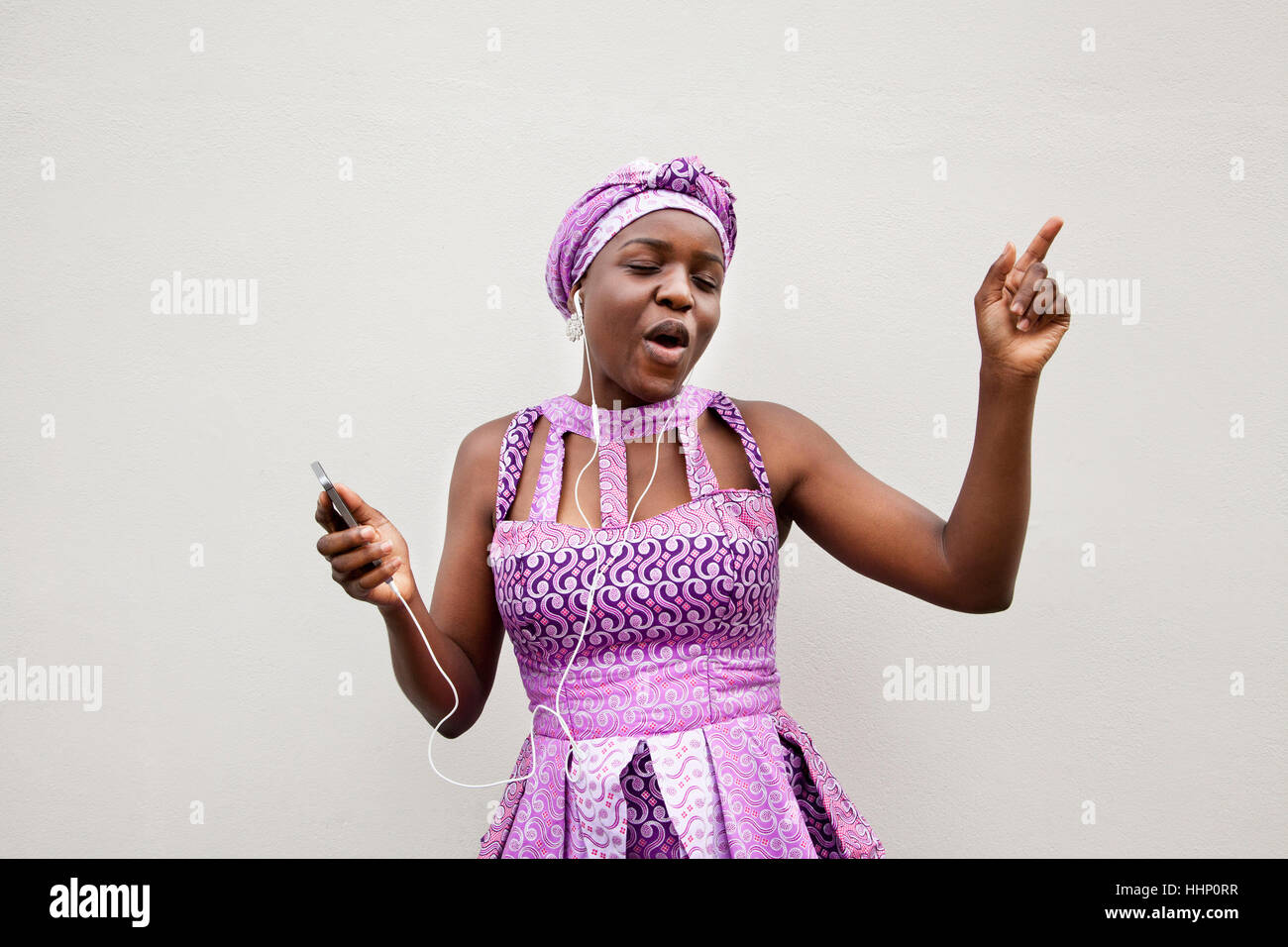 Black woman dancing to music on cell phone Stock Photo - Alamy