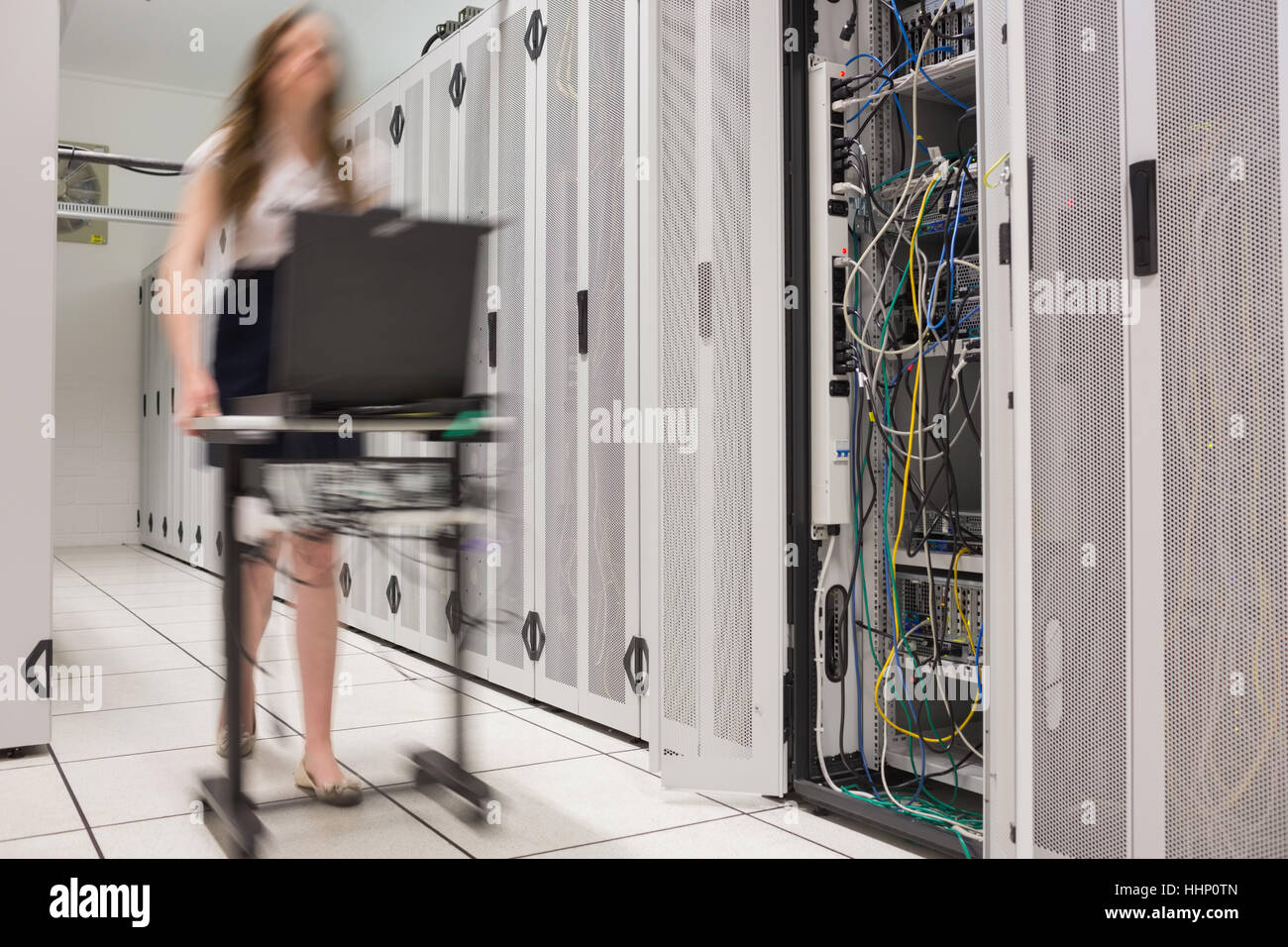 Woman pushing computer to open servers in data center Stock Photo - Alamy