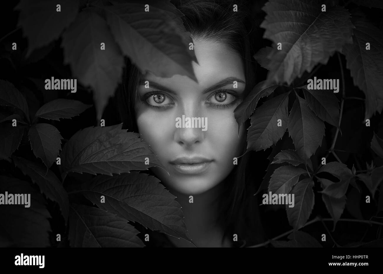 Young woman hiding behind plant hi-res stock photography and images - Alamy