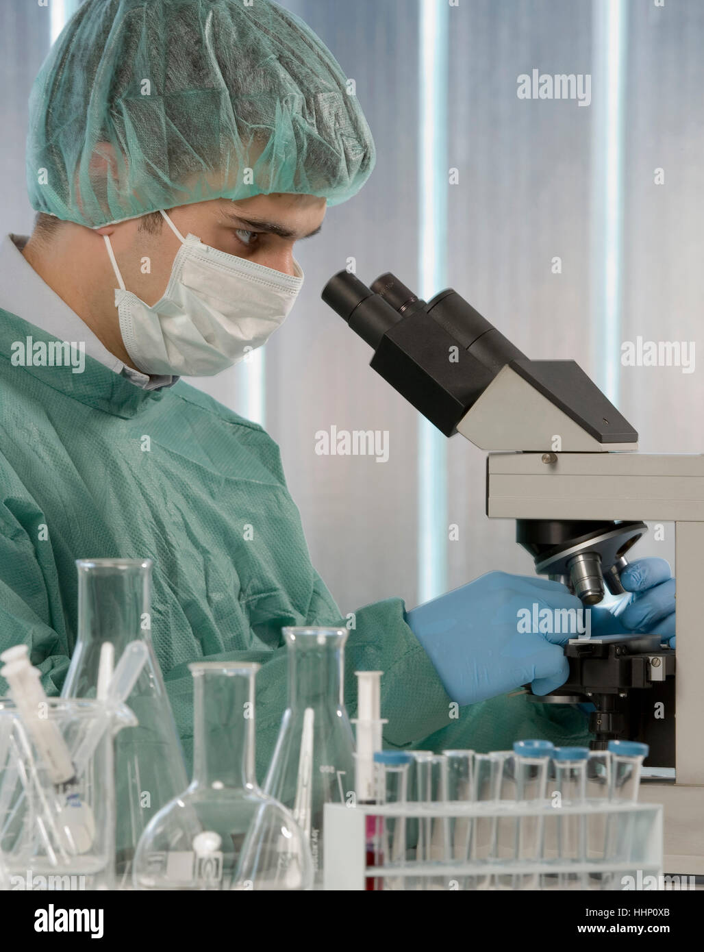 Caucasian scientist using microscope in laboratory Stock Photo - Alamy