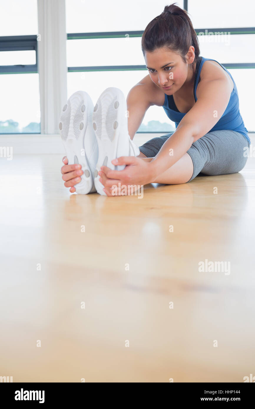 Woman stretching in yoga pose in fitness studio Stock Photo - Alamy