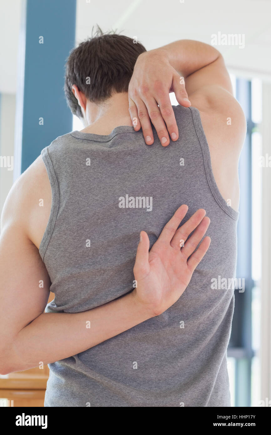 Man is stretching arms at the gym Stock Photo - Alamy