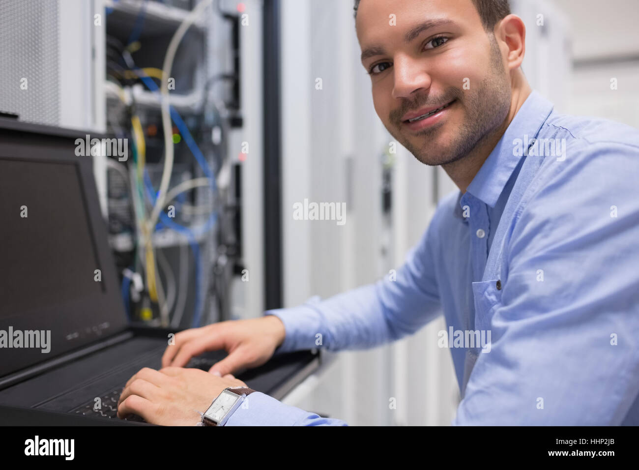 Man searching through servers in data center Stock Photo - Alamy