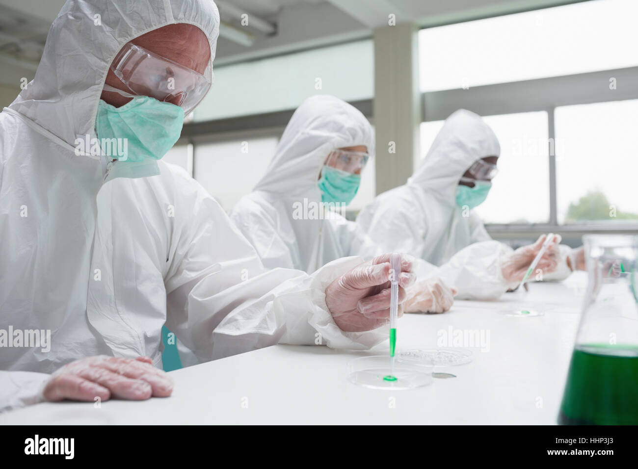 Testing in white suits hi-res stock photography and images - Alamy