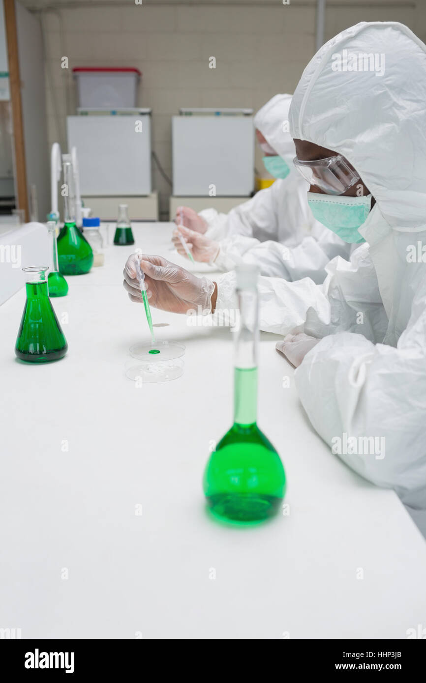Testing in white suits hi-res stock photography and images - Alamy