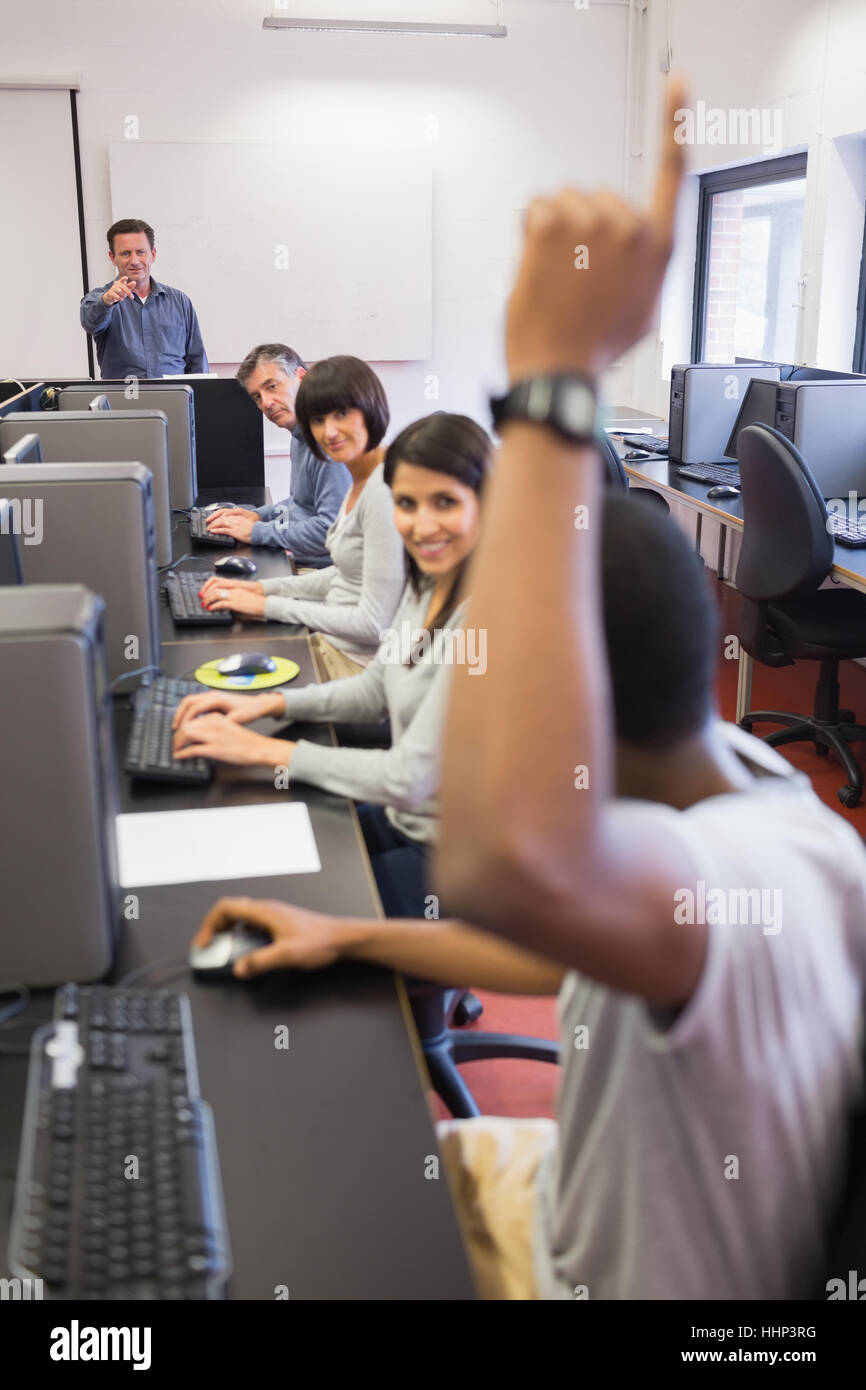 Student raising his hand in computer class Stock Photo - Alamy