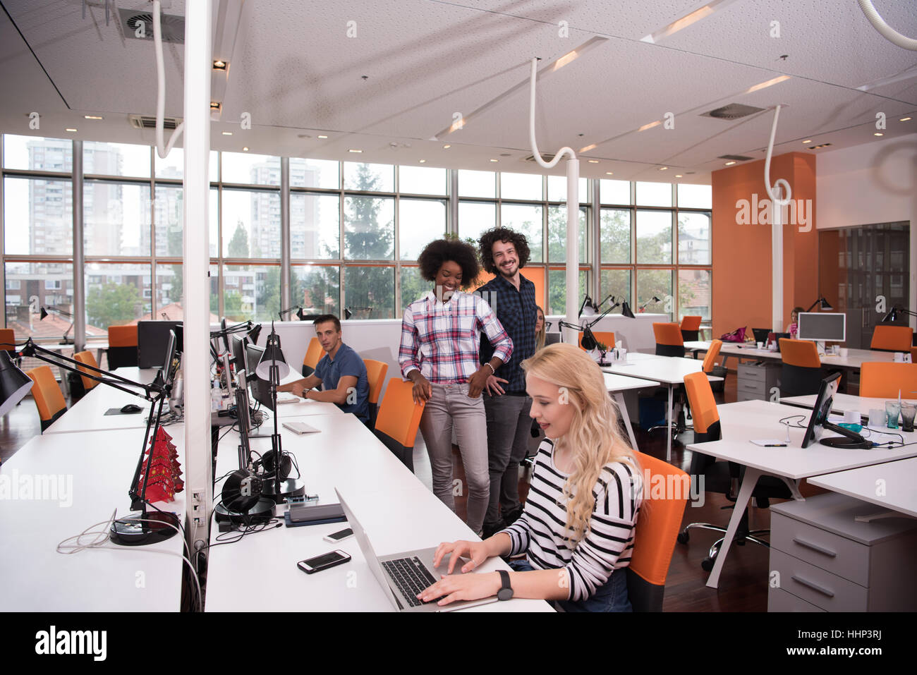 young smiling informal businesswoman working in the office with ...