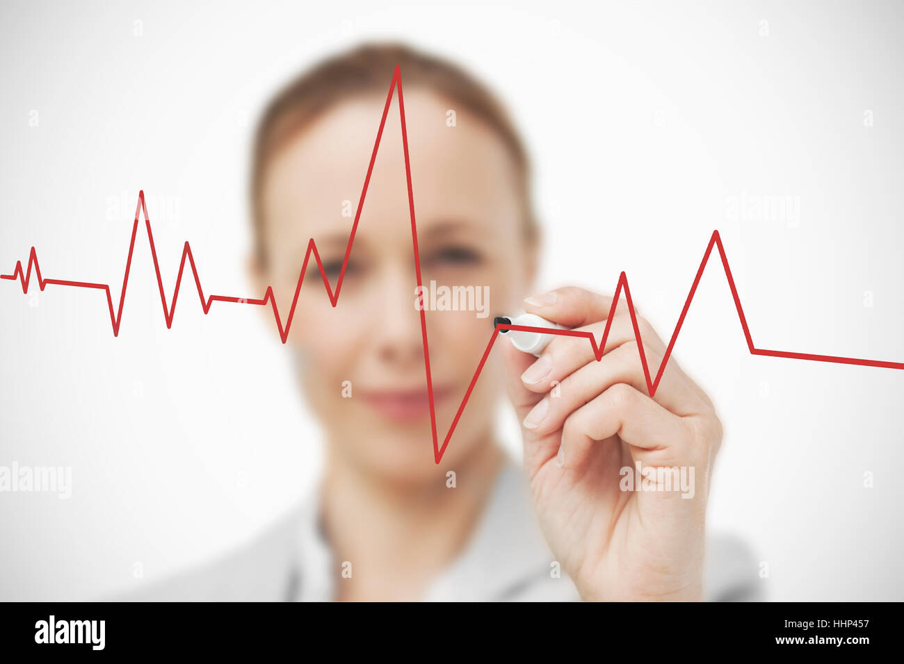 Businesswoman drawing red ECG line Stock Photo - Alamy