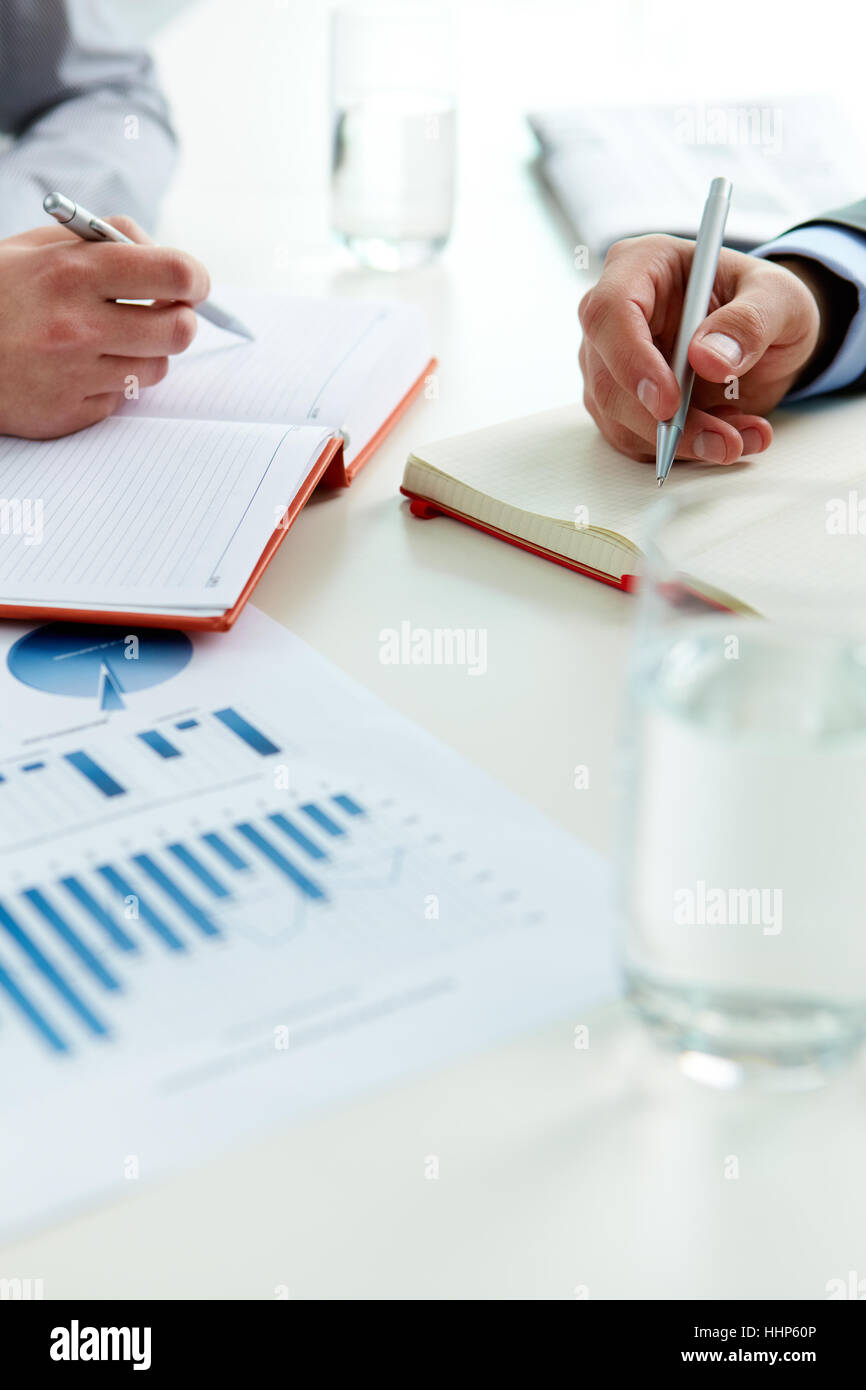 Financial report hands writing charts hi-res stock photography and ...