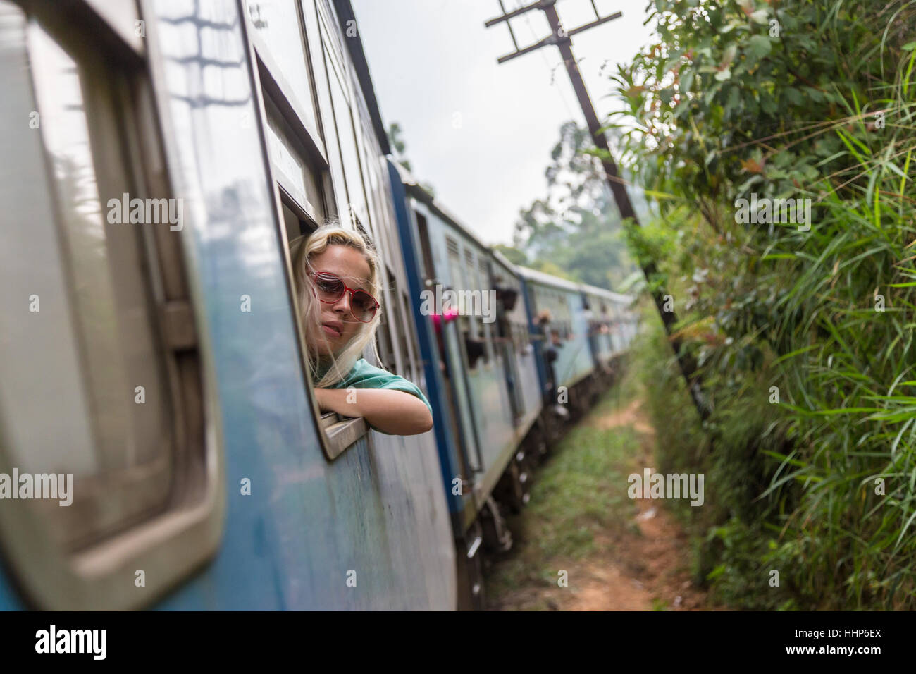 Blonde caucasian woman riding a train, looking trough window Stock ...