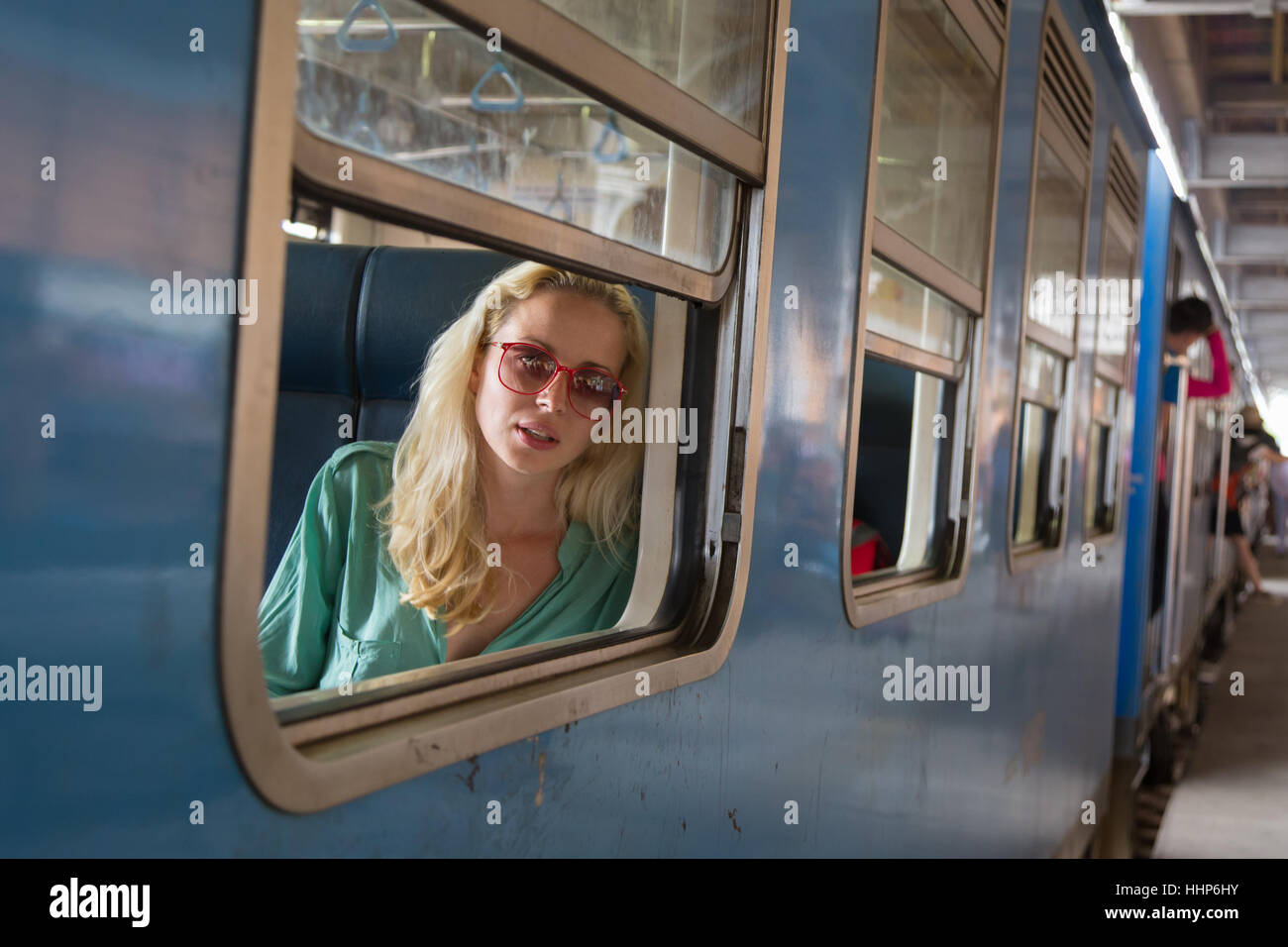 Blonde caucasian woman riding a train, looking trough window Stock ...