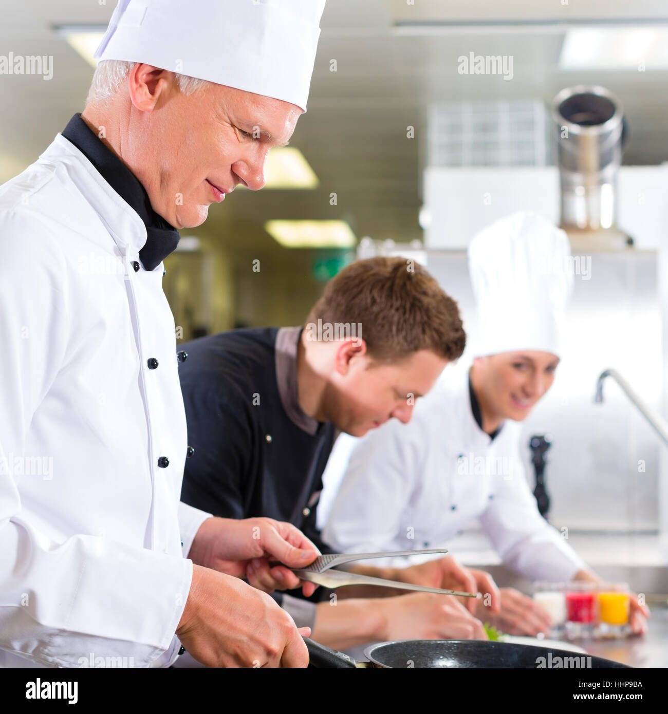 Three cooks in a restaurant hi-res stock photography and images - Alamy