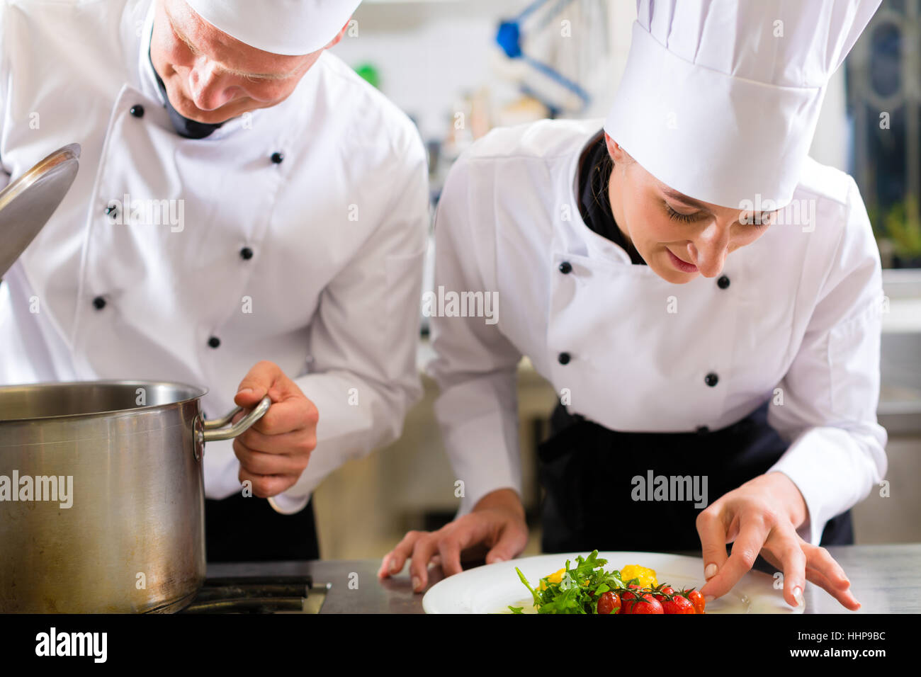 two cooks team in restaurant kitchen Stock Photo - Alamy