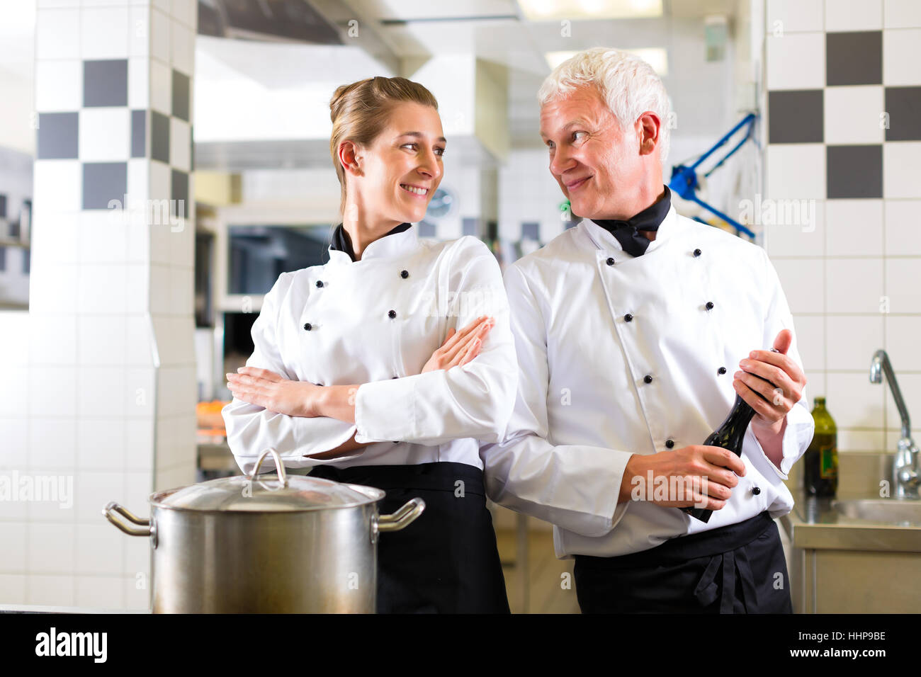 two cooks team in restaurant kitchen Stock Photo - Alamy