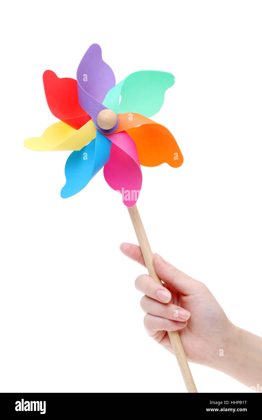 Hand holding colorful toy pinwheel on white background Stock Photo - Alamy
