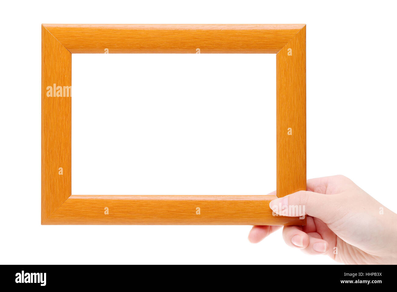 Hand holding wooden picture frame on white background Stock Photo - Alamy