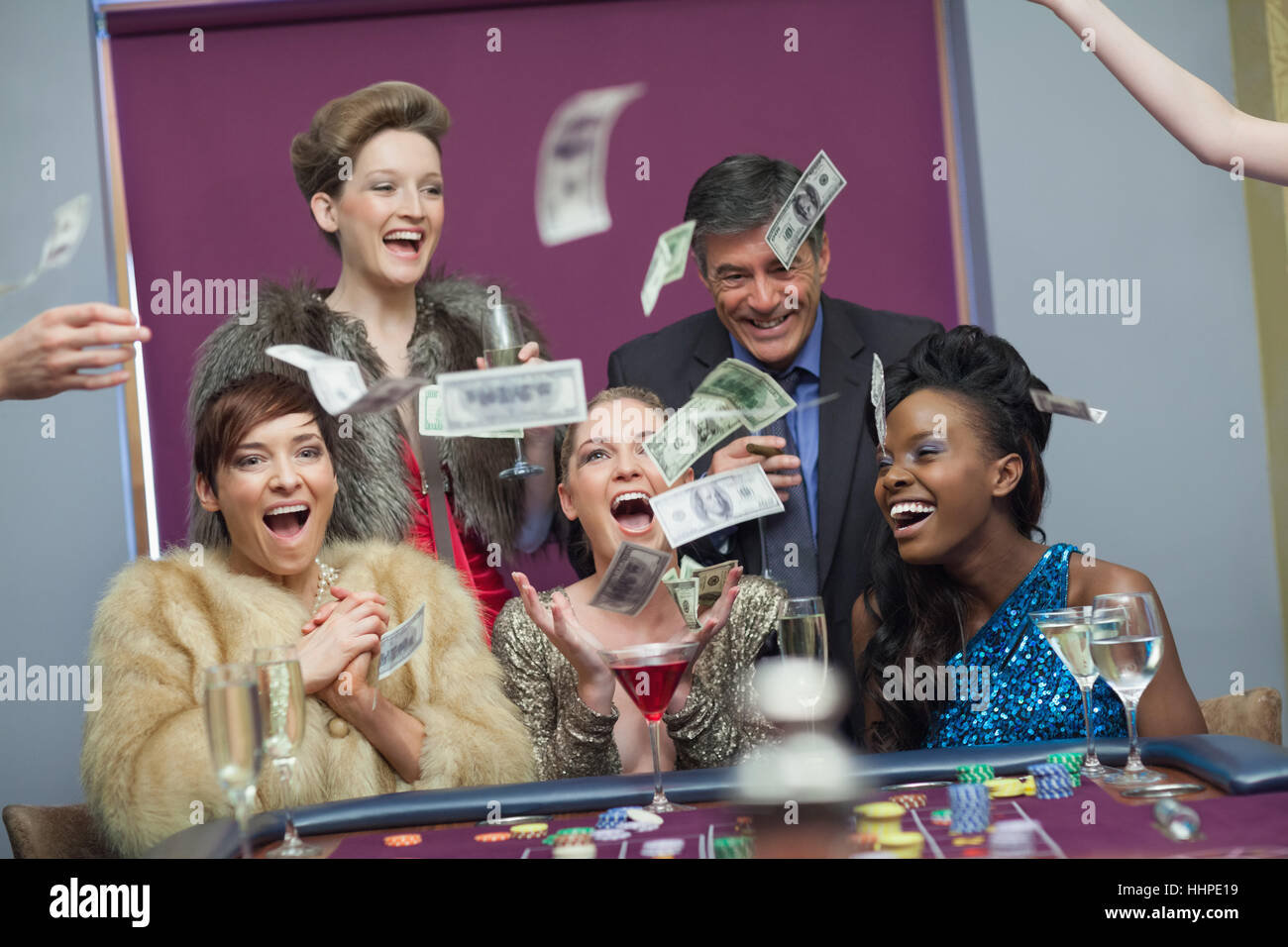 People throwing money having fun at the casino Stock Photo - Alamy