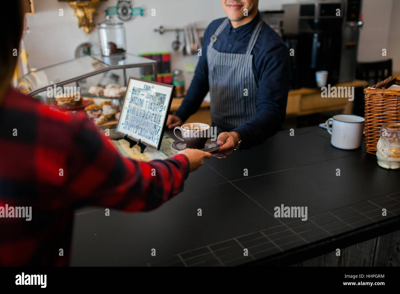Man serving a customer some coffee Stock Photo - Alamy