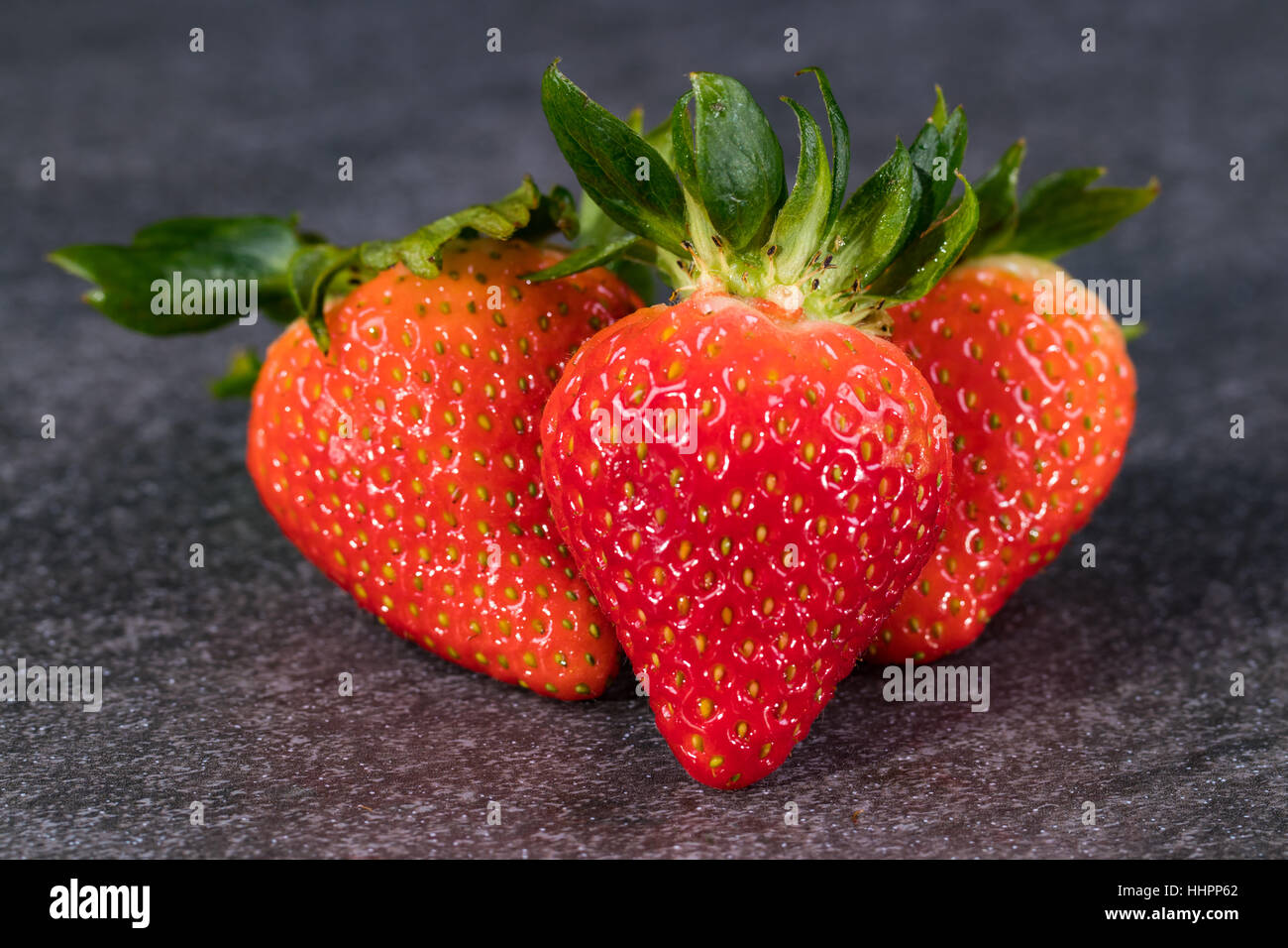 Three strawberries on white background hi-res stock photography and ...
