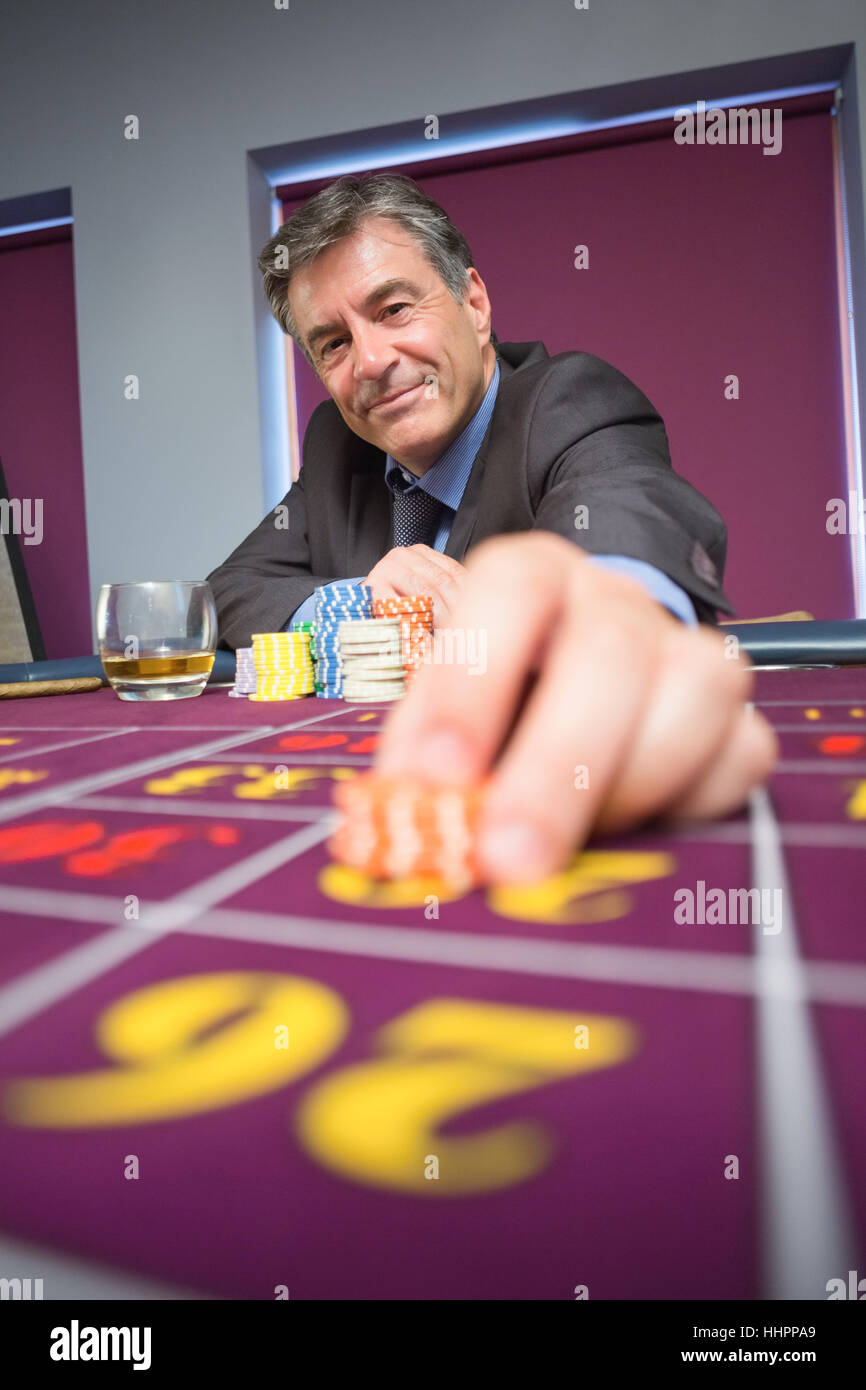 Man placing bet roulette table hi-res stock photography and images - Alamy