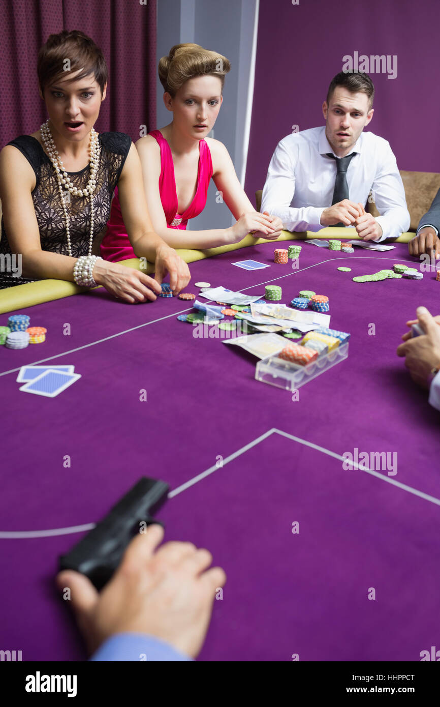 People shocked at gun on poker table Stock Photo - Alamy