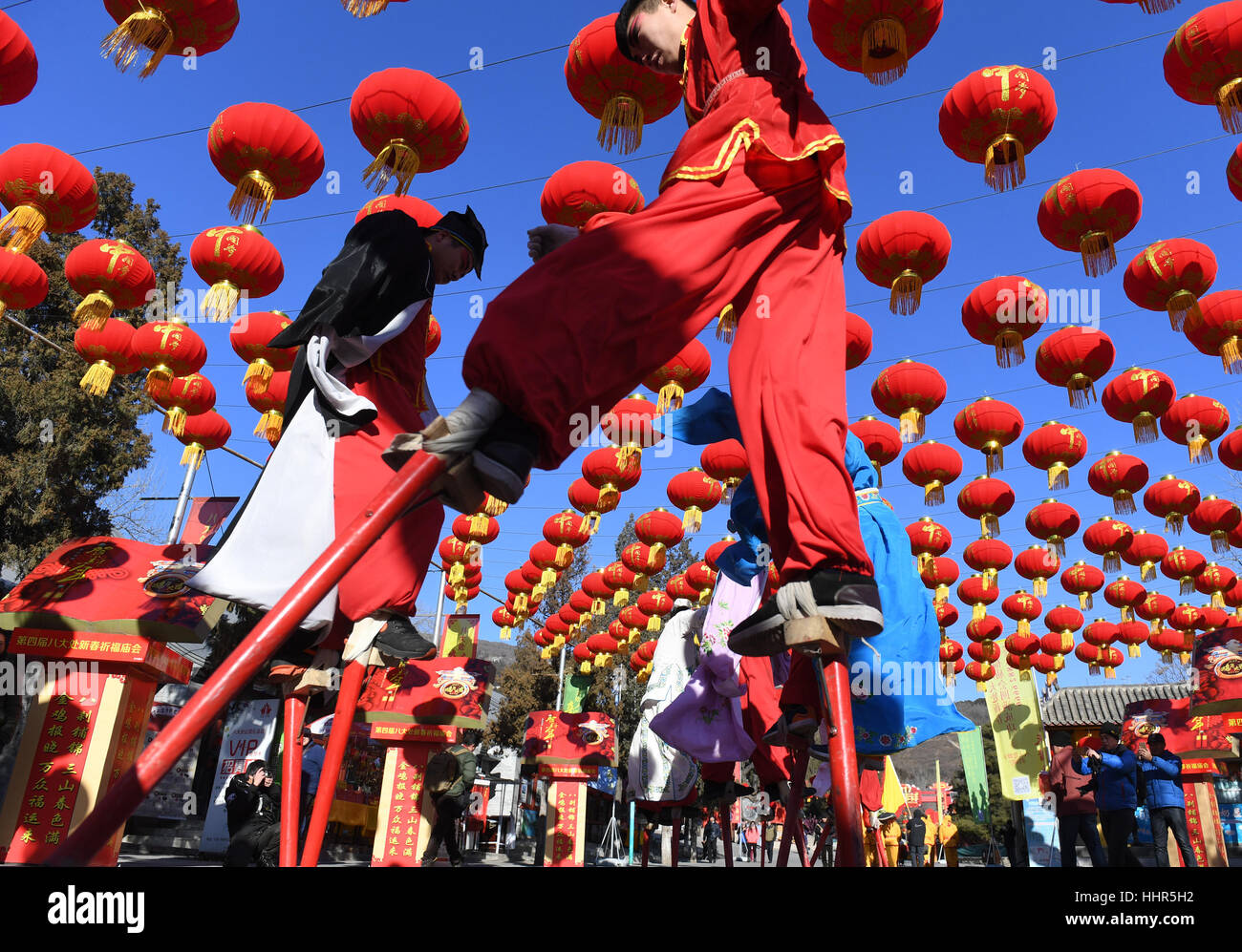Beijing, China. 20th Jan, 2017. Folk artists perform on stilts during a ...