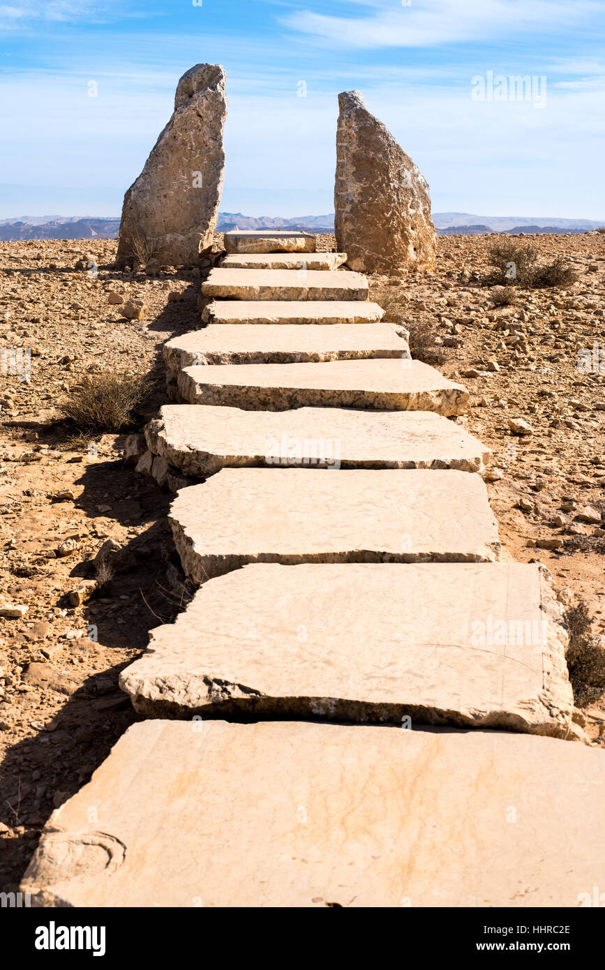 Stone path leading to a gate in a desert landscape. Concept of search ...