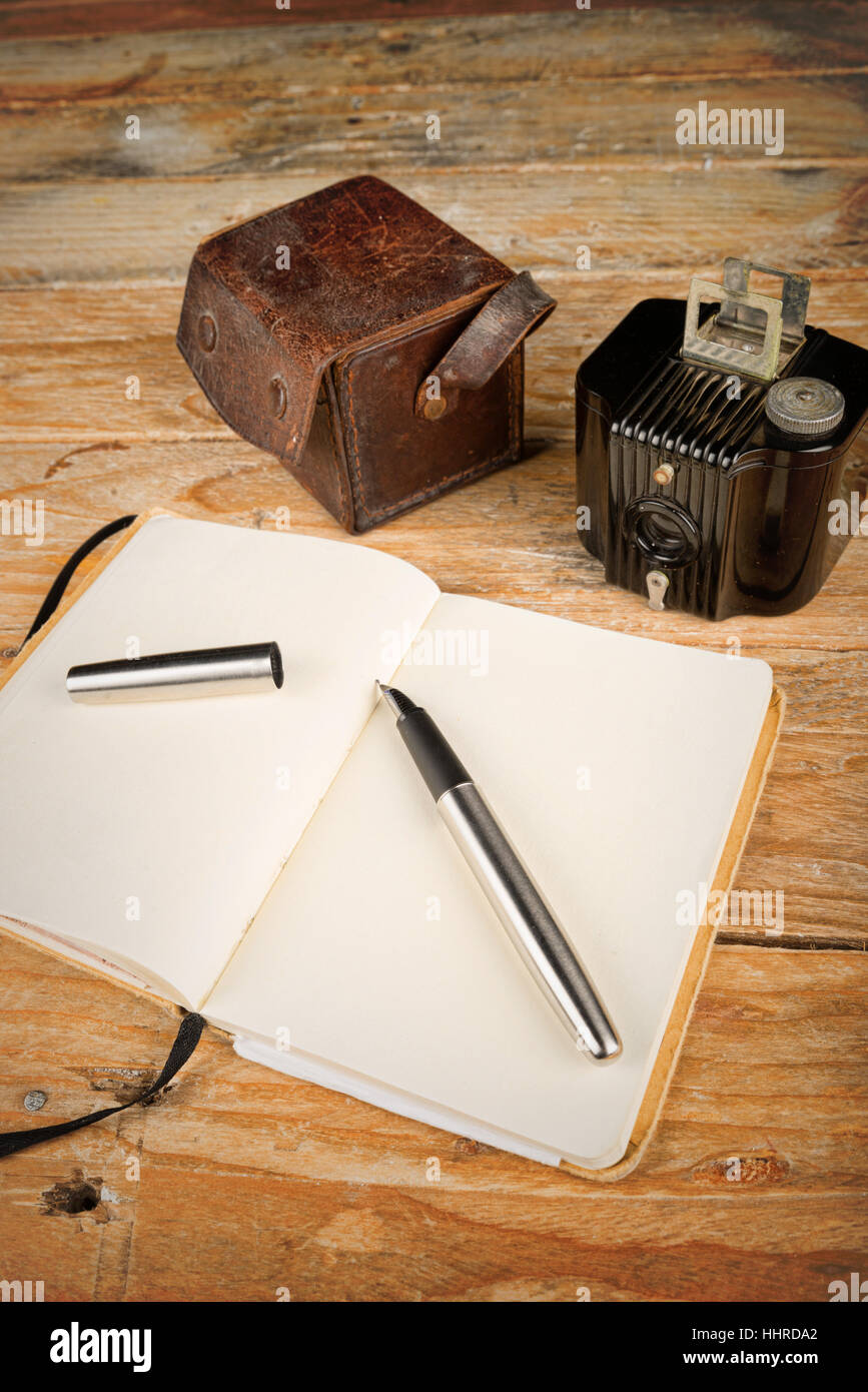 Still life with vintage camera, fountain pen and notebook, a journalism ...