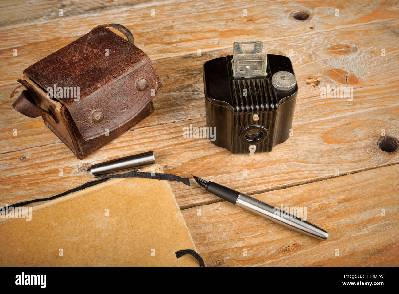 Still life with vintage camera, fountain pen and notebook, a journalism ...