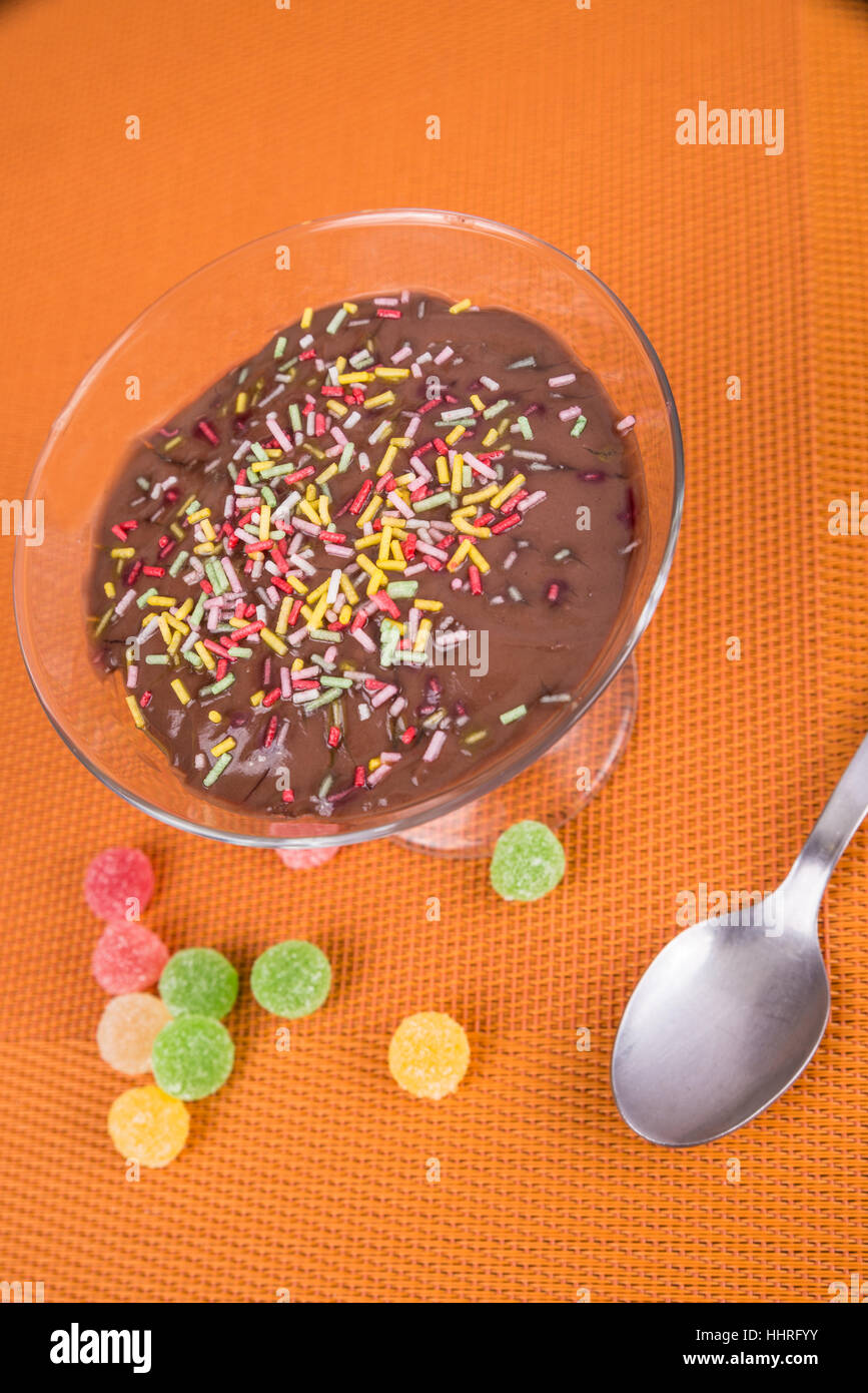 Portion of chocolate pudding decorated with sugar sprinkles Stock Photo ...