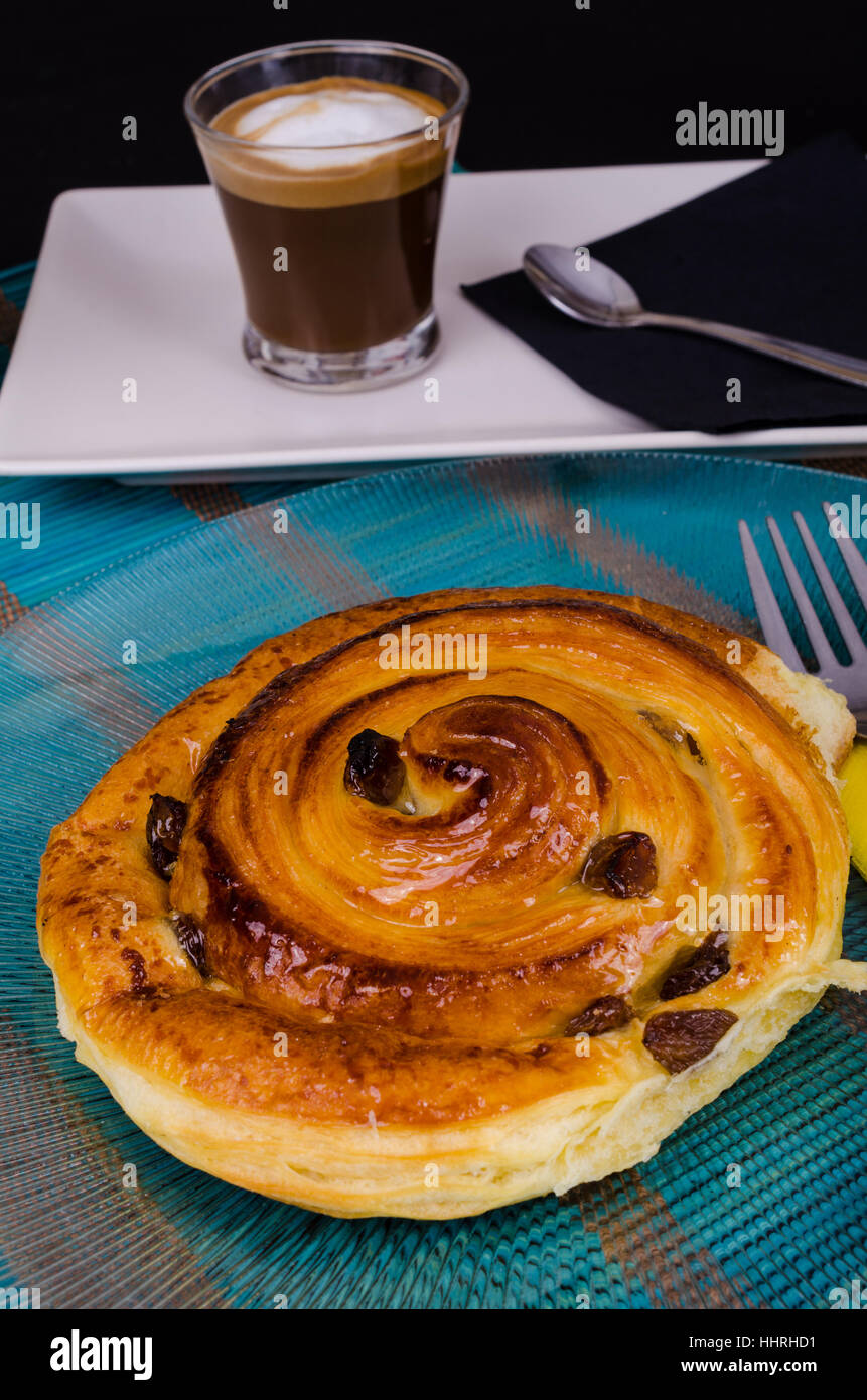 Sweet Spanish spiral bun served as a breakfast with coffee Stock Photo ...