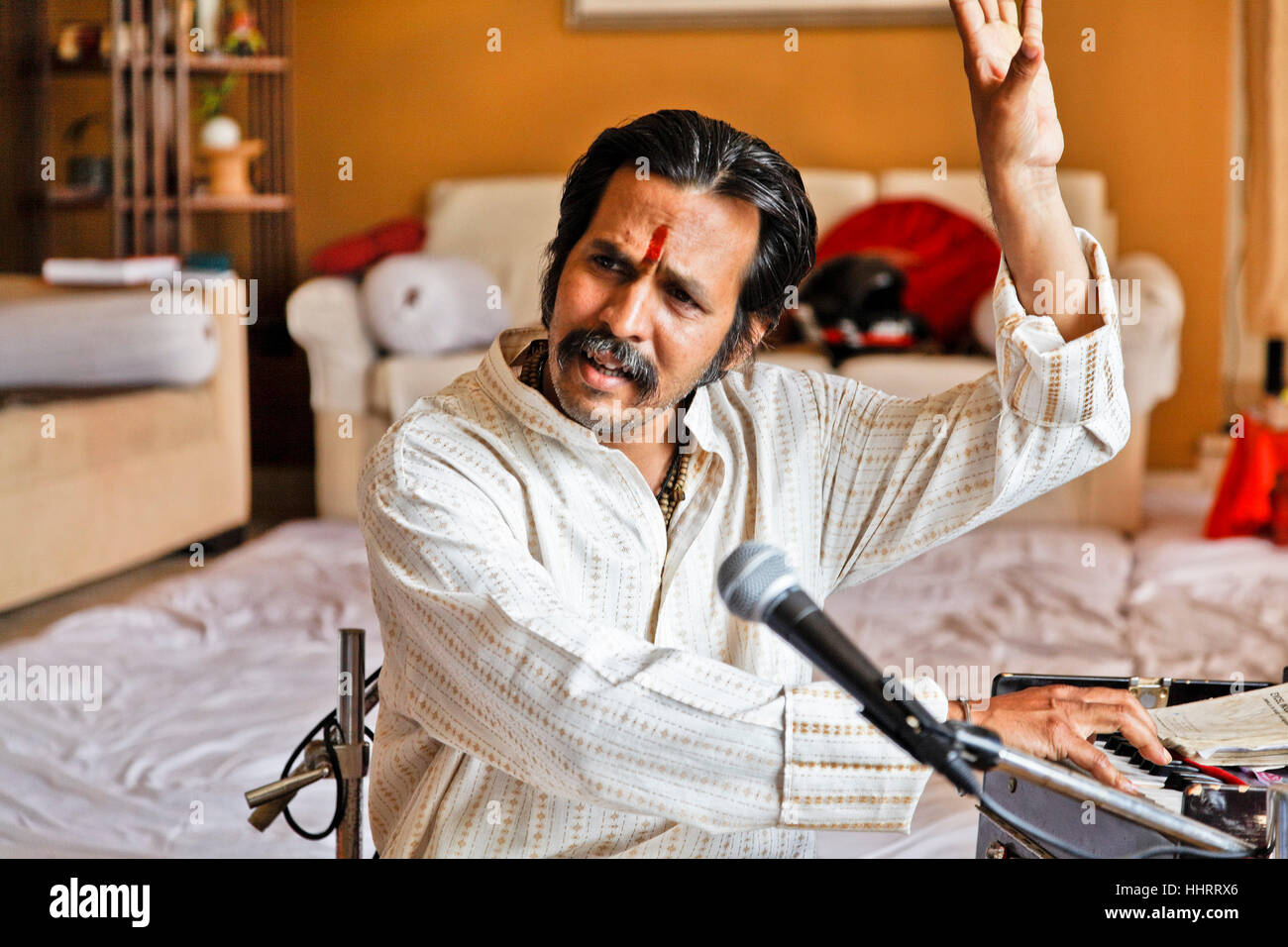 Manoj Desai, Bombay musician, singer and harmonium player rehearsing ...
