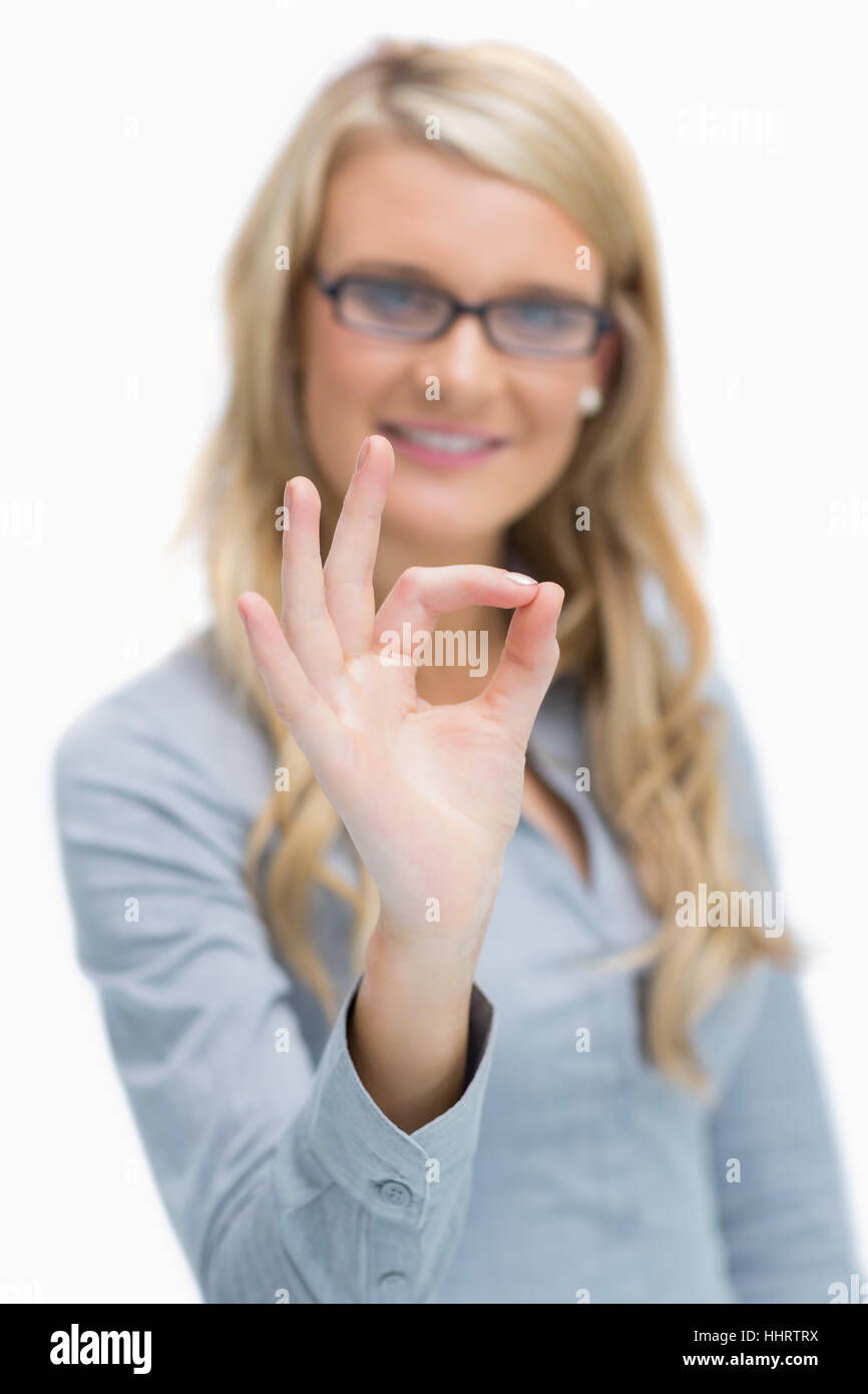 Blonde woman giving ok sign Stock Photo - Alamy