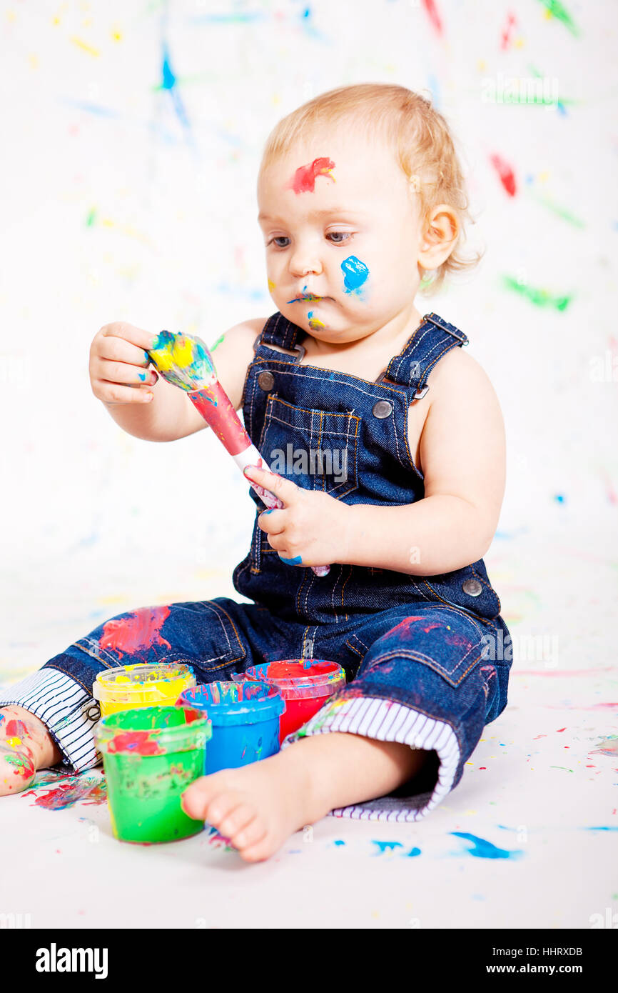 small young baby painted with paints and brushes Stock Photo - Alamy