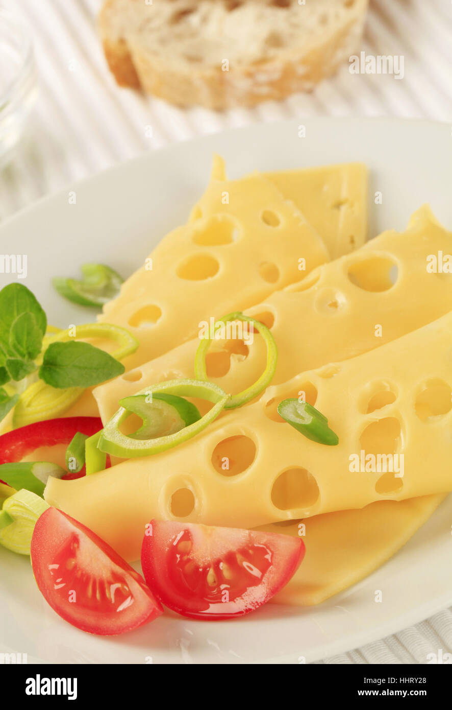 Slices of Swiss cheese sprinkled with spring onion Stock Photo - Alamy
