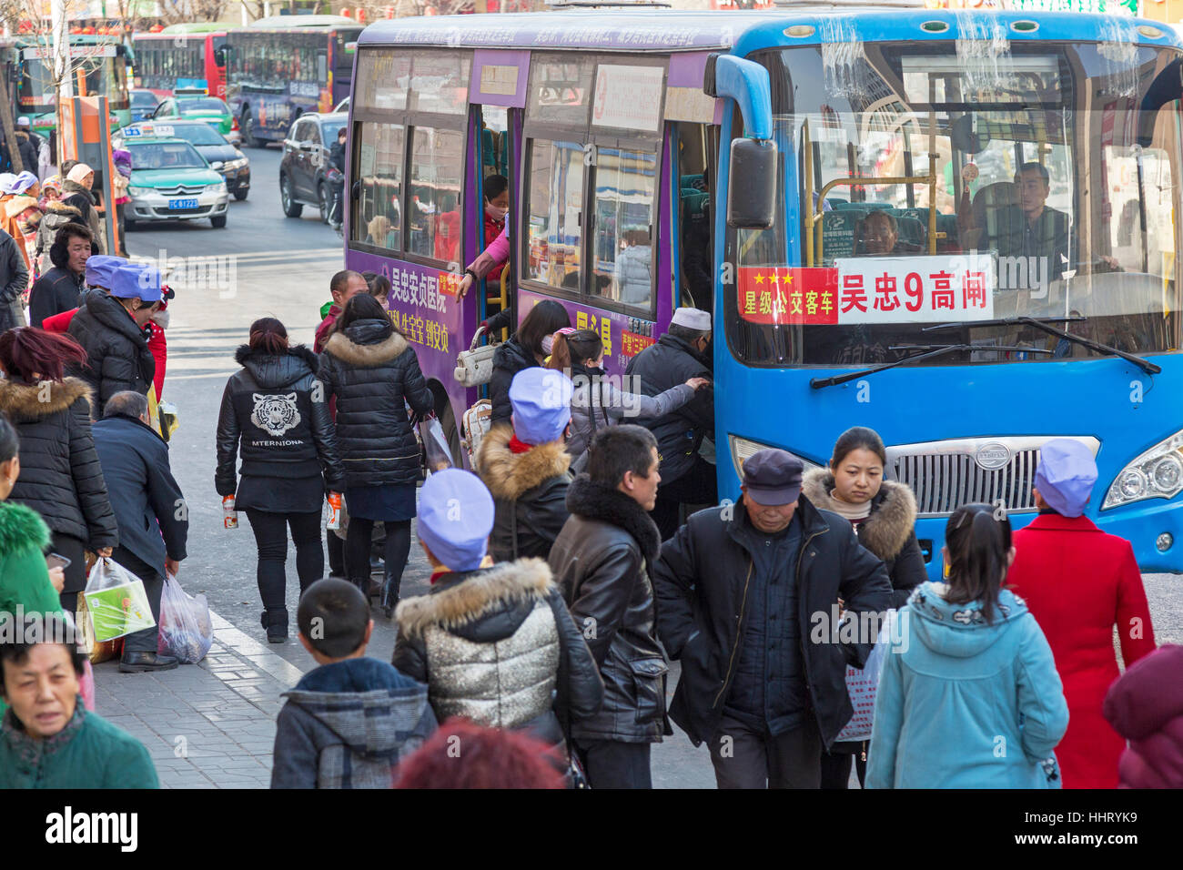 Chinese passengers at bus stop, Wuzhong, Ningxia province, China Stock ...