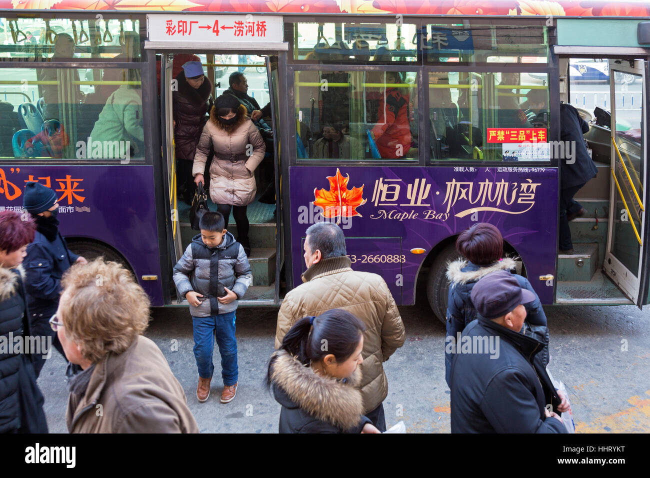 Chinese passengers at bus stop, Wuzhong, Ningxia province, China Stock ...