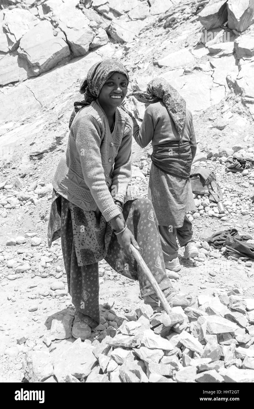 Indian women employed to break up rocks to create stones used as road ...