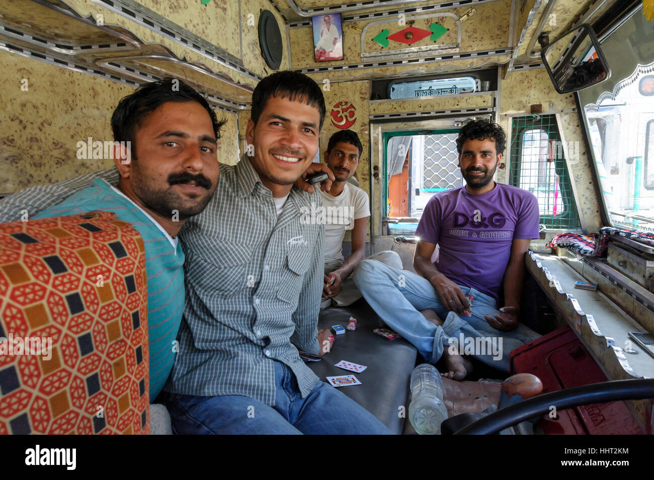 Smiling and happy Indian truck drivers enjoying a break and playing ...
