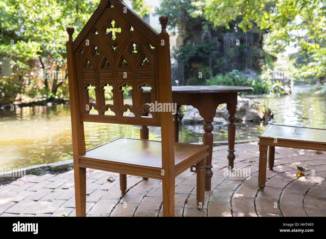 wood chair and table at waterside of pond in garden Stock Photo - Alamy