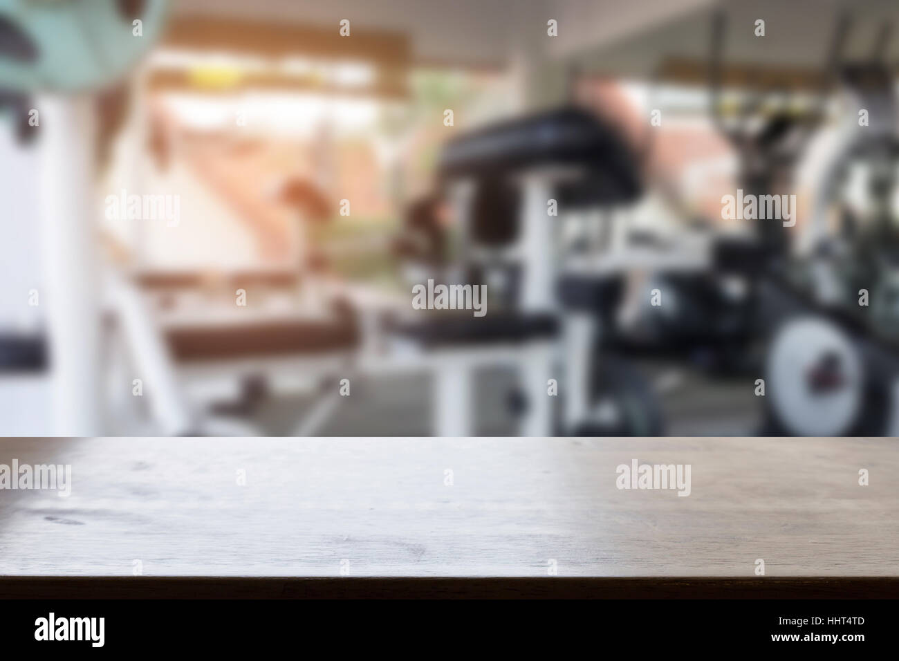 wood table with background of fitness room club interior for montage or ...