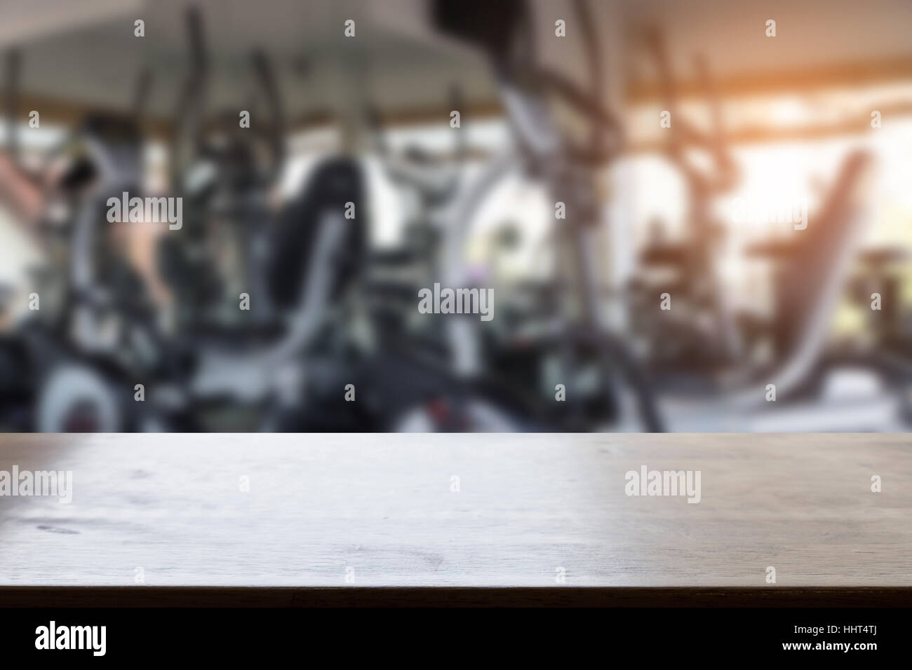 wood table with background of fitness room club interior for montage or ...