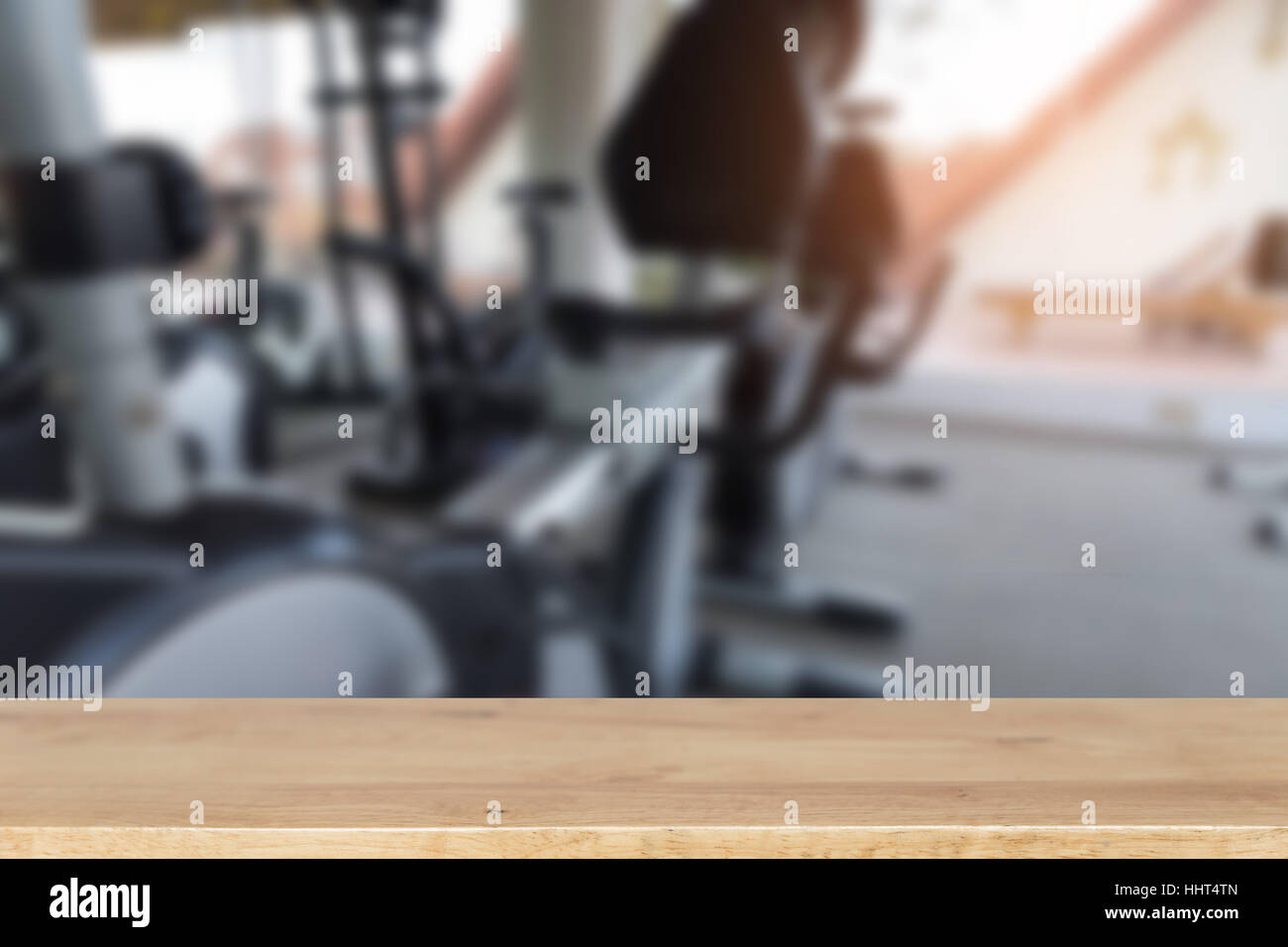 wood table with background of fitness room club interior for montage or ...