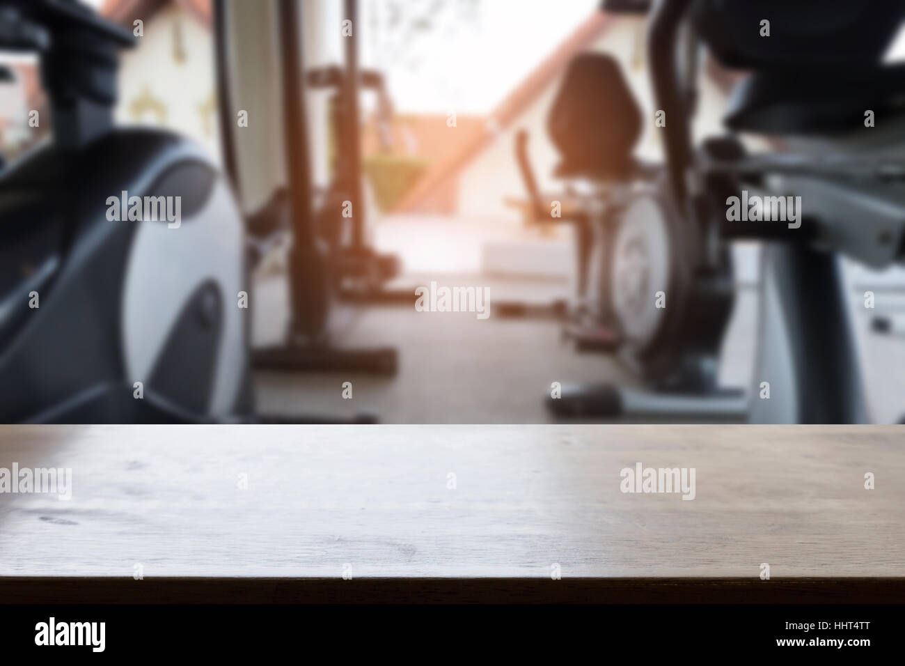 wood table with background of fitness room club interior for montage or ...