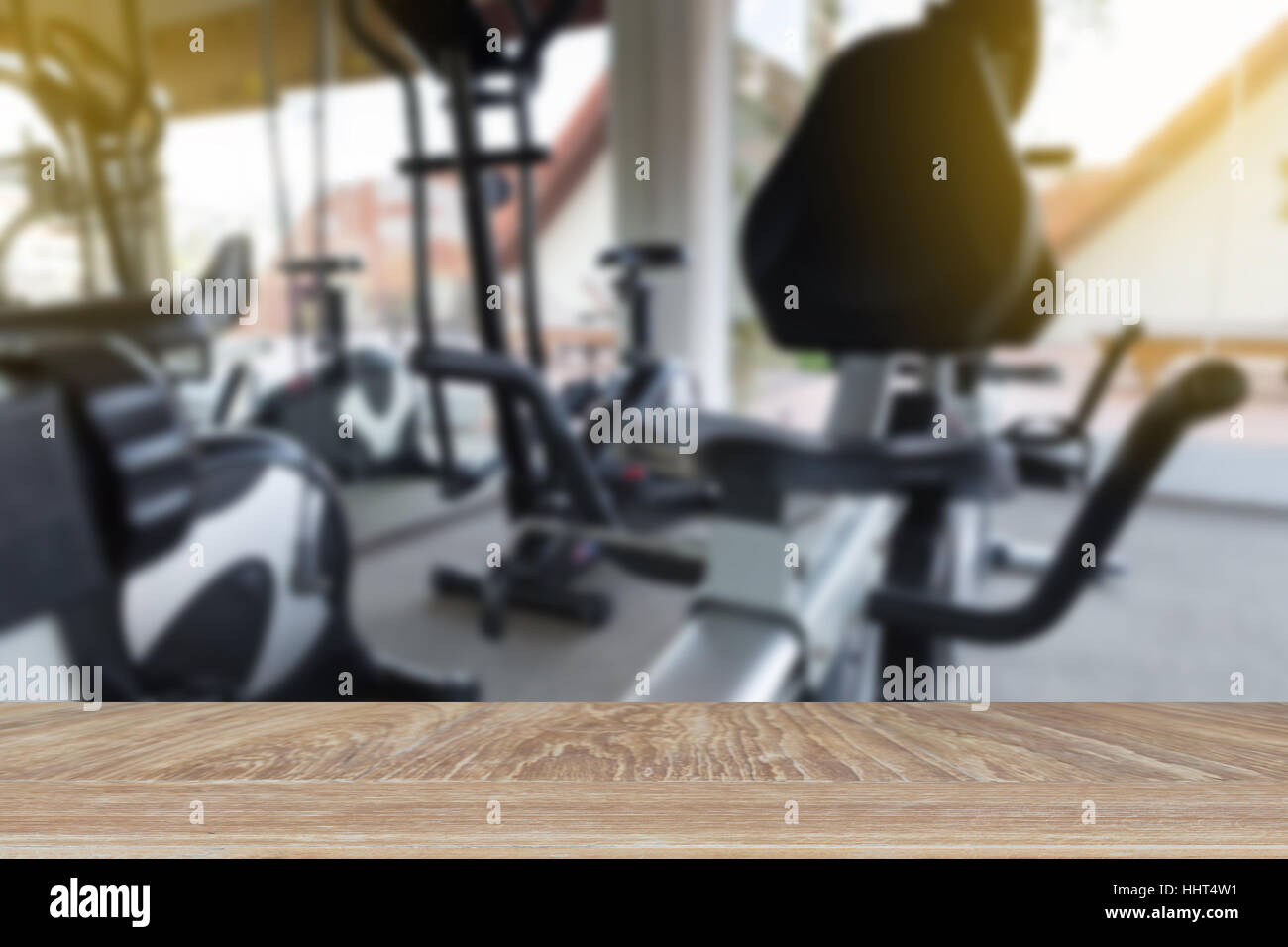 wood table with background of fitness room club interior for montage or ...