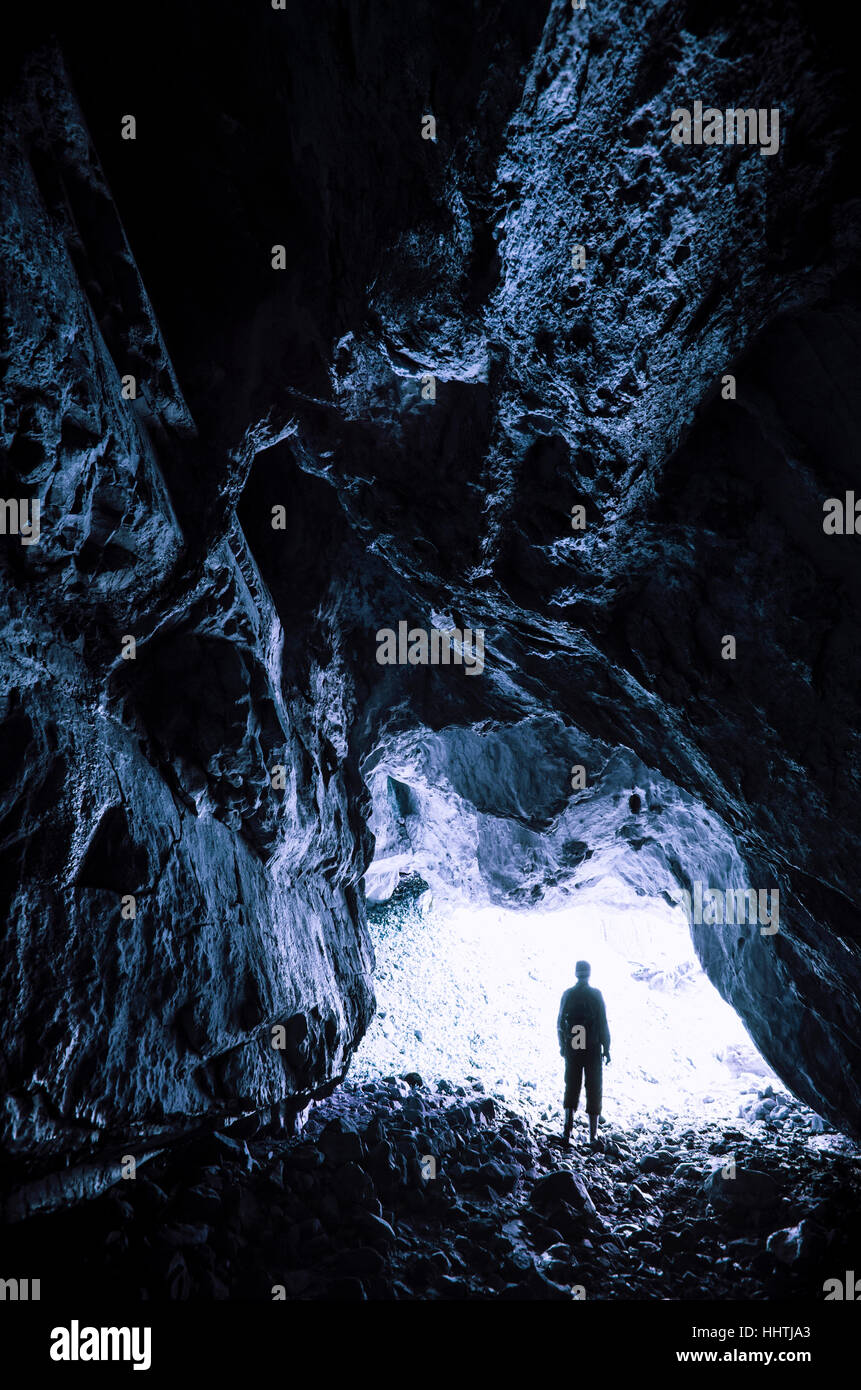 Man silhouette at cave entrance, caving adventure underground Stock ...