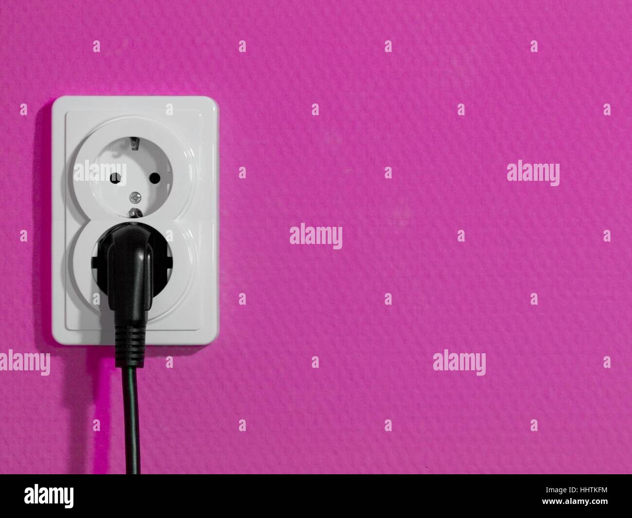 White electric socket on purple wall Stock Photo - Alamy