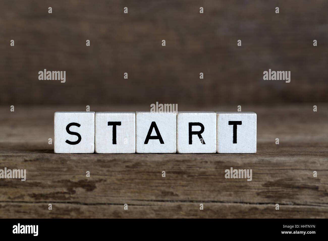 Start, written in cubes on wooden background Stock Photo - Alamy