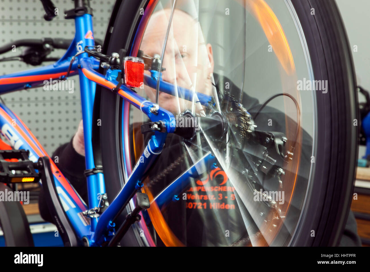 A bicycle mechanic during the inspection at a mountain bike in his ...